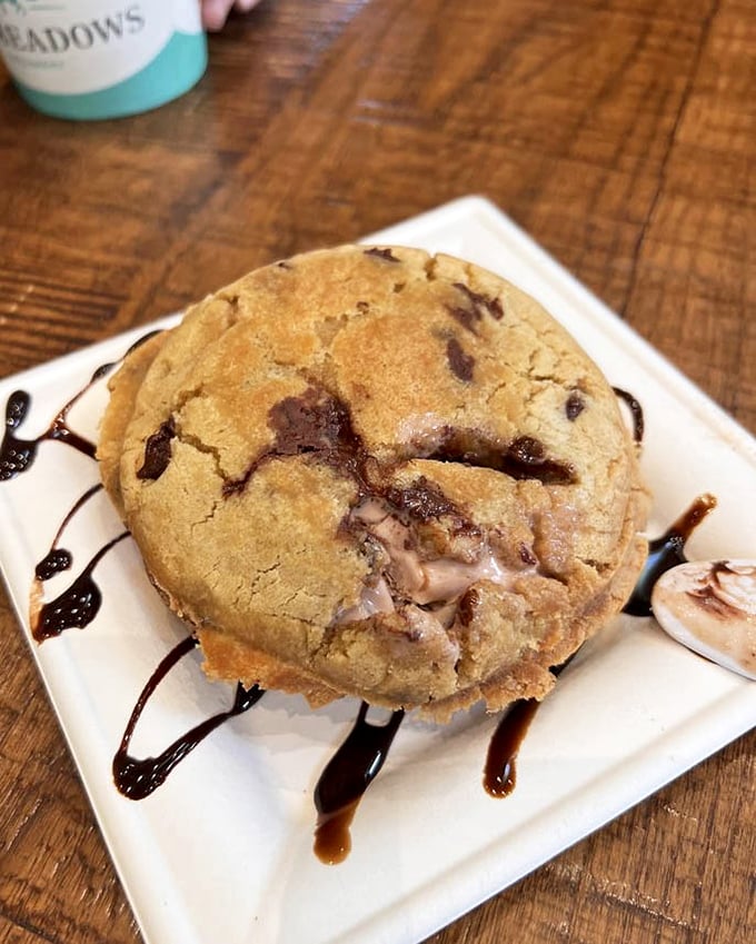 This warm cookie creation drizzled with chocolate sauce isn't just dessert – it's what dreams are made of when cookies fall asleep thinking about ice cream.