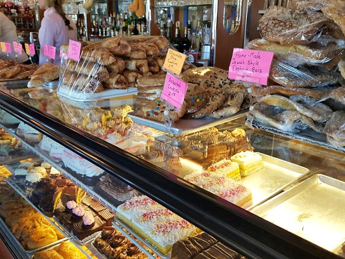 The dessert case at Blue Colony doesn't just tempt—it hypnotizes with layer cakes and pastries that make willpower vanish faster than free samples.