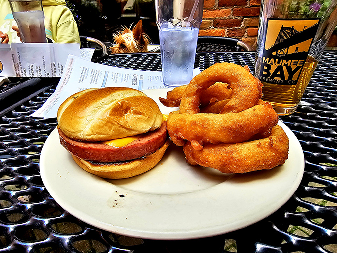 A burger and onion rings that would make any cardiologist nervously update their contact information on your emergency card.