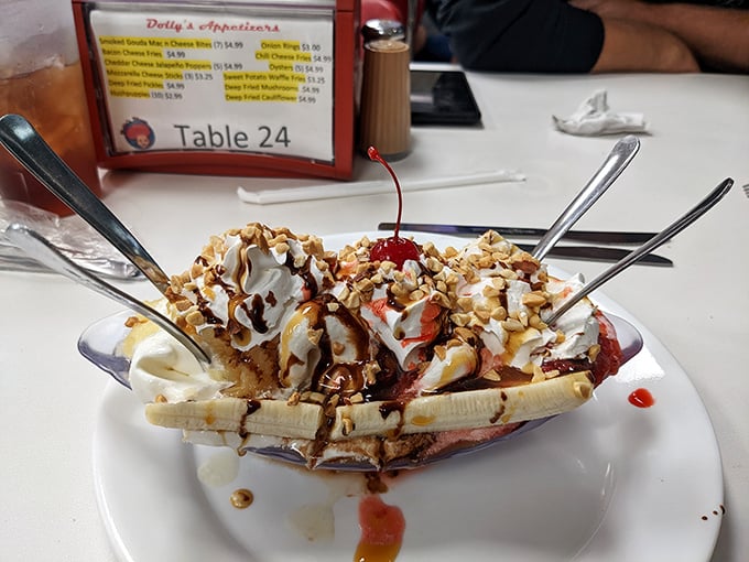 Banana split architecture at its finest—a structural marvel of ice cream, whipped cream, and toppings that would make Frank Lloyd Wright put down his blueprints and pick up a spoon.