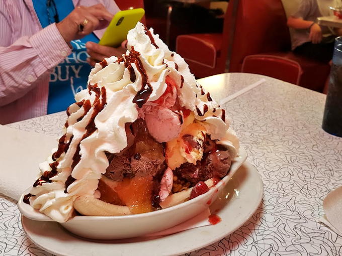 The banana split doesn't whisper "indulgence"—it shouts it from the mountaintops with a megaphone of whipped cream and chocolate drizzle.