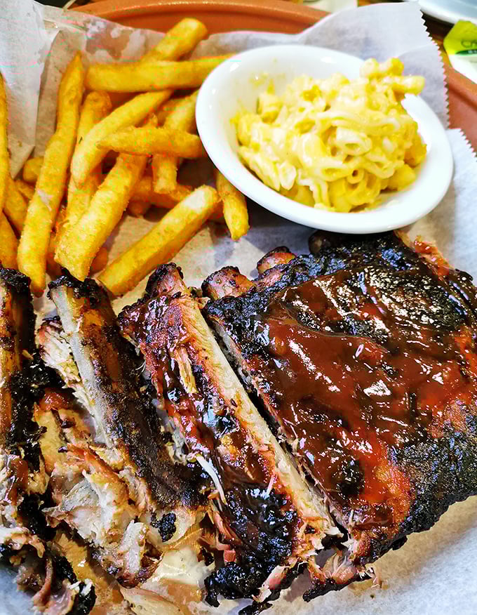 Barbecue ribs with that perfect smoke ring and char. The kind of dish that makes napkins necessary and diets optional.