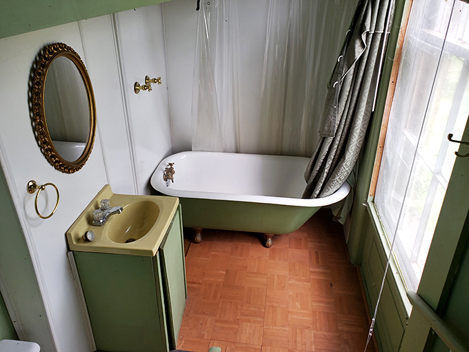 Even the bathroom maintains that authentic 19th-century charm – modern convenience meets Victorian elegance in perfect harmony.