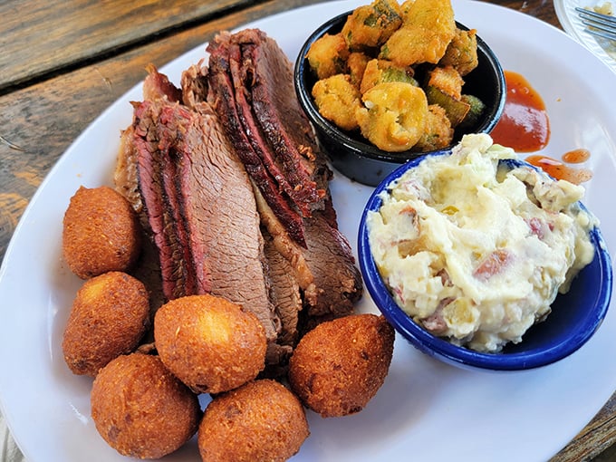 Brisket with that telltale smoke ring, hushpuppies standing at attention, and sides that know their supporting role. This plate deserves a standing ovation.