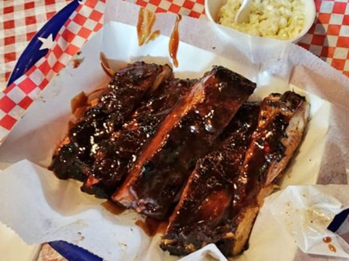 Ribs so good they make you forget table manners exist. The glossy bark gives way to meat that surrenders from the bone with dignified ease.