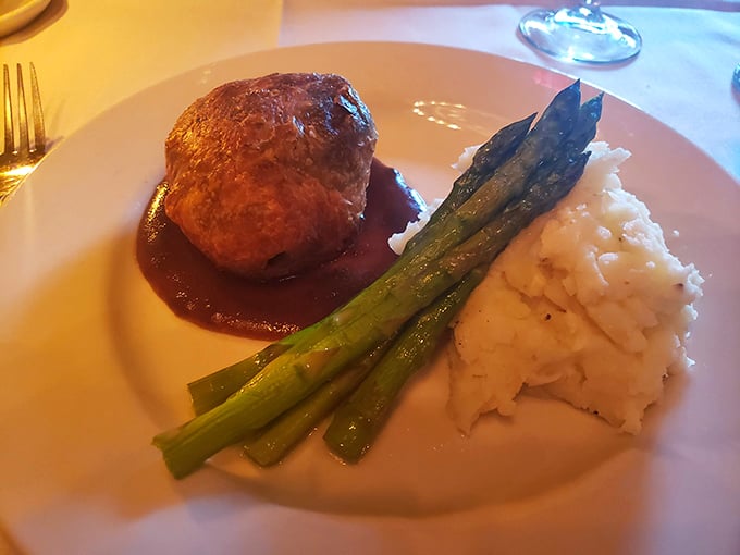 This plate whispers "special occasion" with every bite—tender beef Wellington, creamy mashed potatoes, and asparagus spears standing at attention like delicious soldiers.