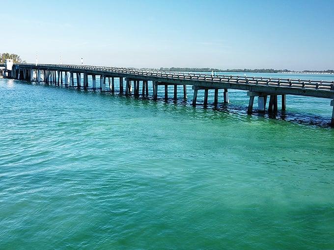 Old Florida engineering meets Caribbean-blue waters—a pier stretching toward the horizon like nature's welcome mat.