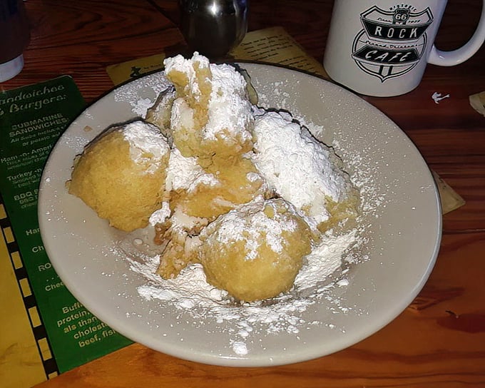 These beignets aren't just dusted with powdered sugar—they're having a full-on snowball fight with it. Sweet surrender!