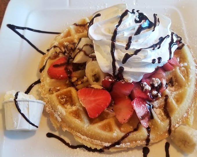 A Belgian waffle that's dressed for success with fresh strawberries, bananas, whipped cream, and chocolate drizzle—breakfast or dessert? Why choose?