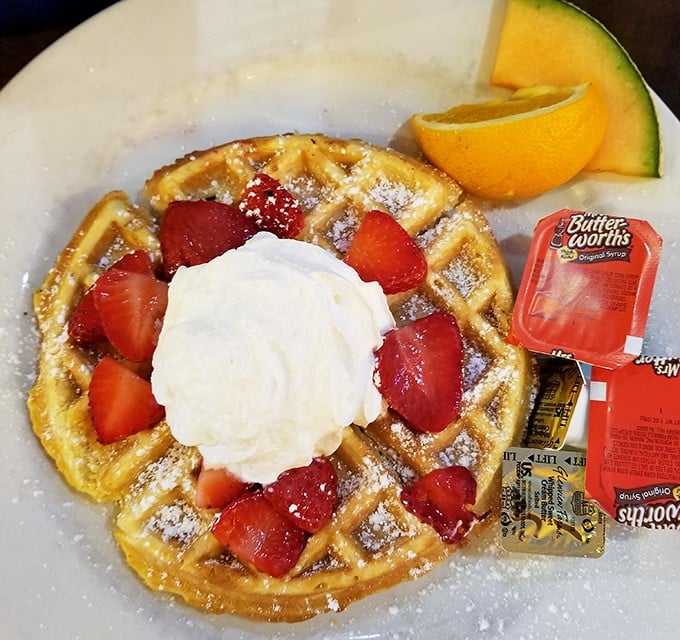 This Belgian waffle with fresh strawberries and whipped cream is what breakfast dreams are made of – crisp exterior, fluffy inside, berry perfection.