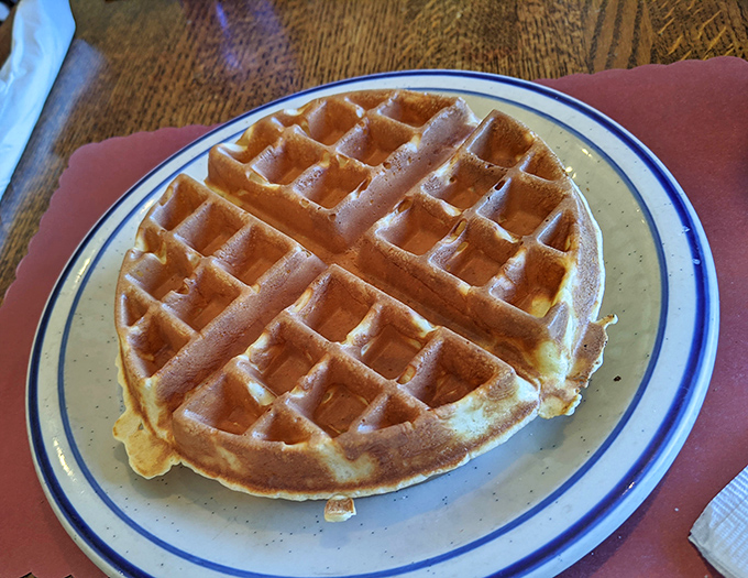 This Belgian waffle isn't just breakfast—it's architecture. Those perfect grid patterns are practically begging for maple syrup rivers.