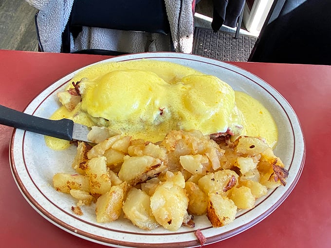This Benedict isn't just breakfast—it's morning architecture, with golden home fries providing the perfect foundation for any day worth having.