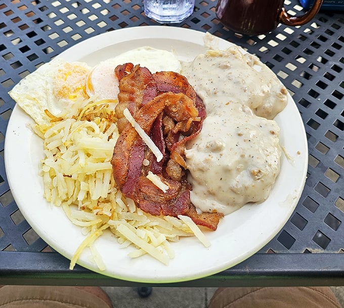 Biscuits and gravy with eggs and bacon—the breakfast that says "your diet starts tomorrow" in the most delicious way possible.