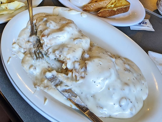 These biscuits and gravy aren't just breakfast, they're an edible security blanket – smothered in creamy, peppery goodness that soothes the soul.