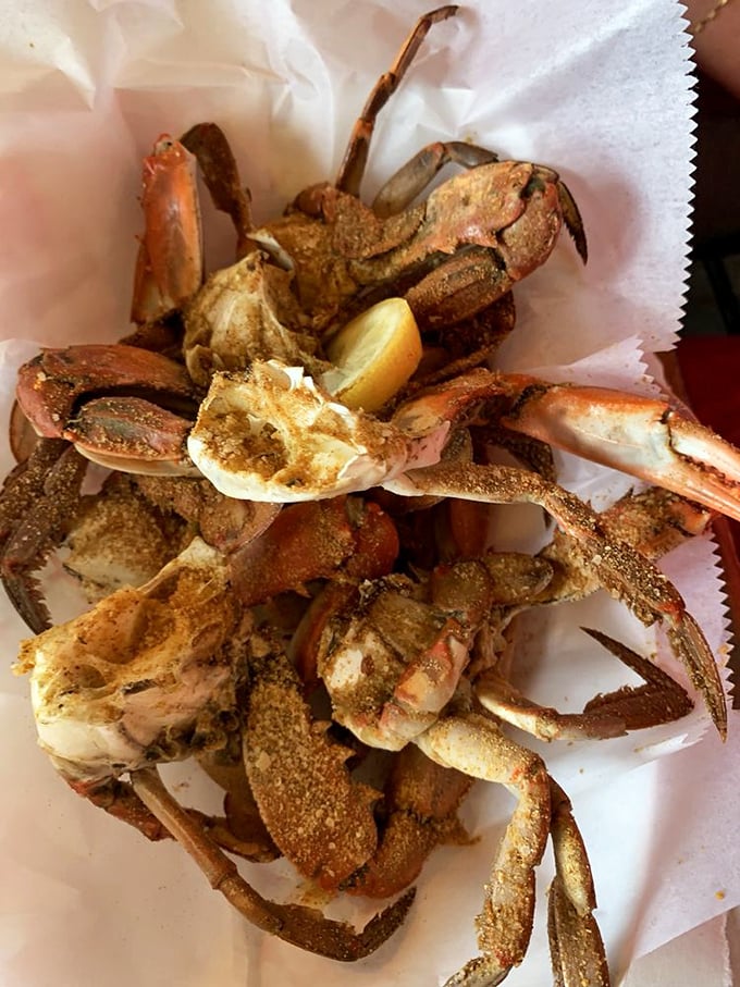 Seasoned blue crabs on parchment paper—nature's puzzle box where the reward for your efforts is sweet, succulent meat.