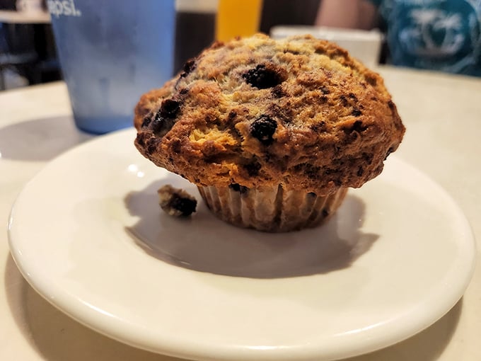The star of the show in all its glory – a blueberry muffin so packed with berries it looks like it's trying to smuggle jewels across the border.