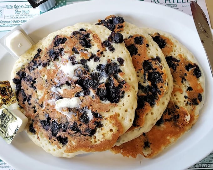 Blueberry pancakes so plump and perfect, they make you wonder if the blueberries volunteered for this delicious fate just to make your morning better.
