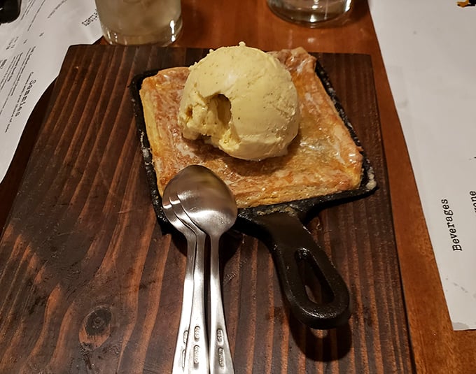 This isn't just dessert, it's therapy – warm blueberry pie topped with slowly melting vanilla ice cream, served in a skillet that keeps the magic happening bite after bite.