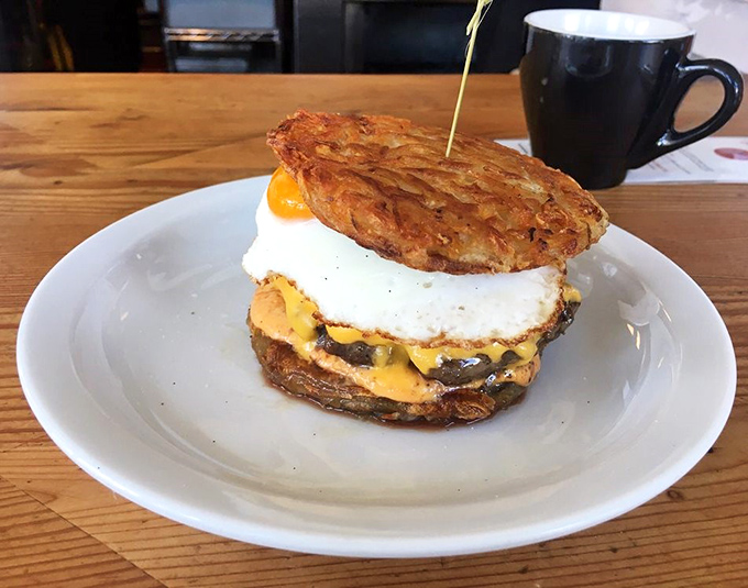 Breakfast reimagined: hash browns as buns, egg and cheese as companions to beef—morning and noon having a delicious conversation on one plate.