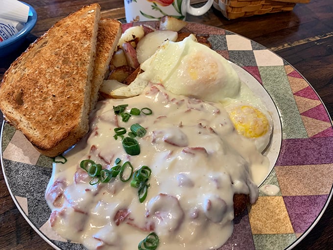 Cream gravy cascading over what appears to be chicken-fried heaven—this plate doesn't just feed your body, it hugs your soul. 