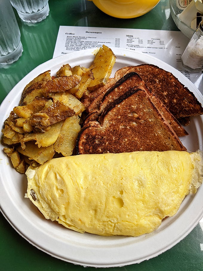 The breakfast trinity: a perfectly executed omelet, golden home fries, and toast—proof that sometimes the classics need no improvement.