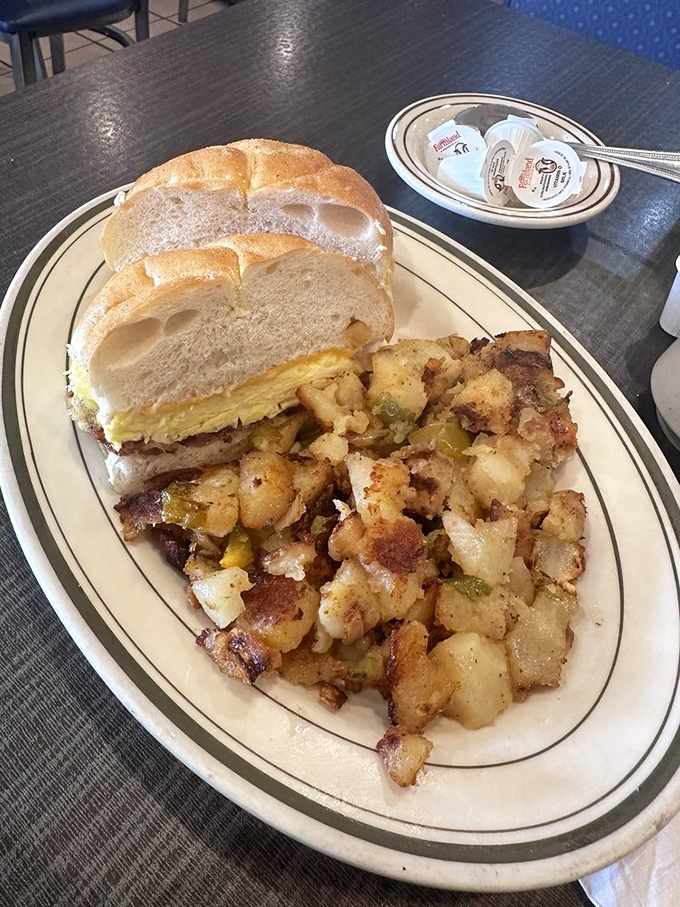 The breakfast sandwich and home fries combo—where fluffy eggs meet toasted roll and those potatoes achieve that mythical crispy-outside, tender-inside perfection.