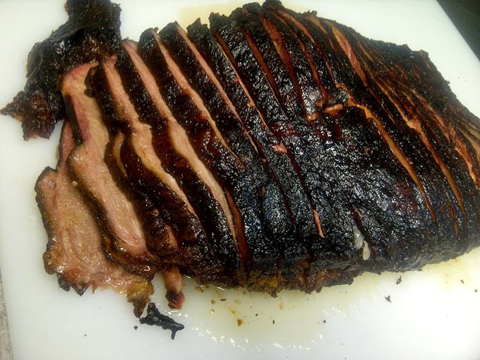 Brisket sliced thicker than a suspenseful plot. That smoke ring isn't just for show—it's the barbecue equivalent of a designer label proving its authenticity.
