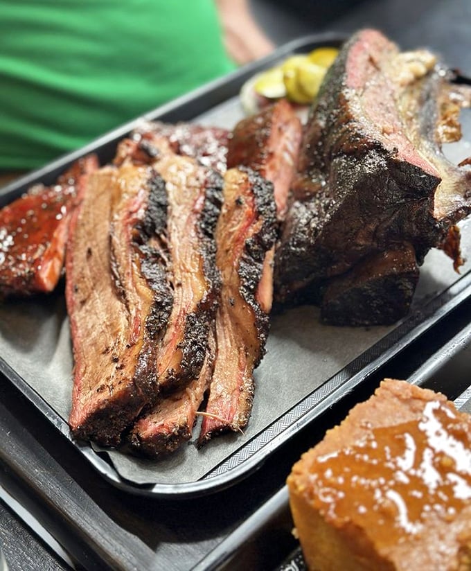 Brisket with that textbook bark and smoke ring that would make a Texan weep with joy. Meat this good doesn't need sauce—but nobody's judging if you add some.