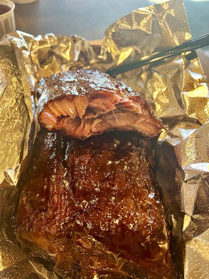 That brisket has the kind of bark that makes tree bark jealous—a glistening, pepper-crusted exterior giving way to meat so tender it surrenders instantly.