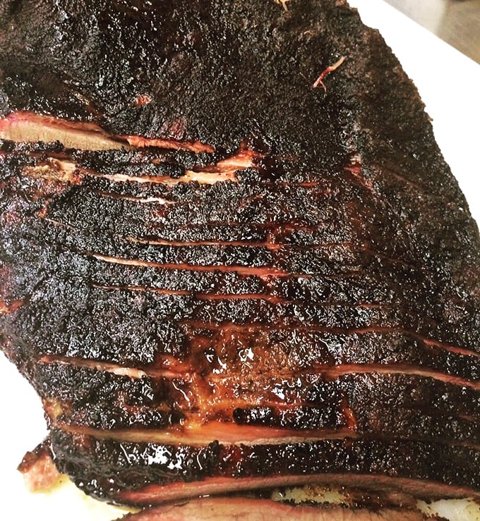 Brisket with a bark so perfect it belongs in a museum. The smoke ring is practically a halo—barbecue beatification in meat form.