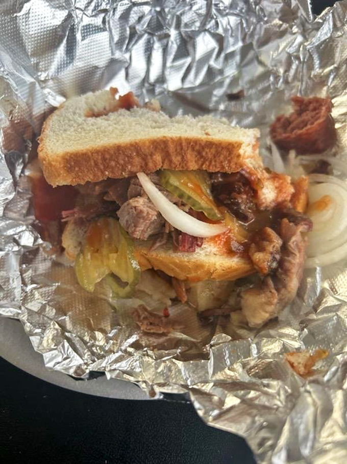 This isn't just a sandwich; it's an architectural marvel of tender brisket, pickles, onions, and white bread—the Parthenon of portable barbecue pleasure.