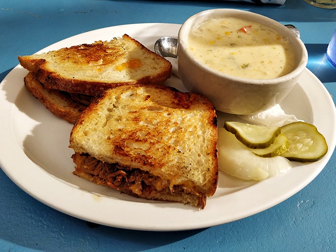 This isn't just a sandwich; it's architecture – perfectly grilled bread housing a treasure of brisket, with soup standing guard alongside.