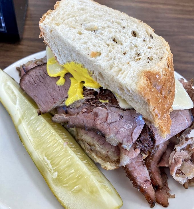 The brisket sandwich that launched a thousand road trips. Tender meat, hearty bread, and that essential pickle—simplicity that somehow tastes like coming home.