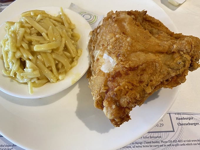 Broasted chicken that renders conversation impossible except for appreciative mumbles. Those noodles aren't just a side—they're co-stars.