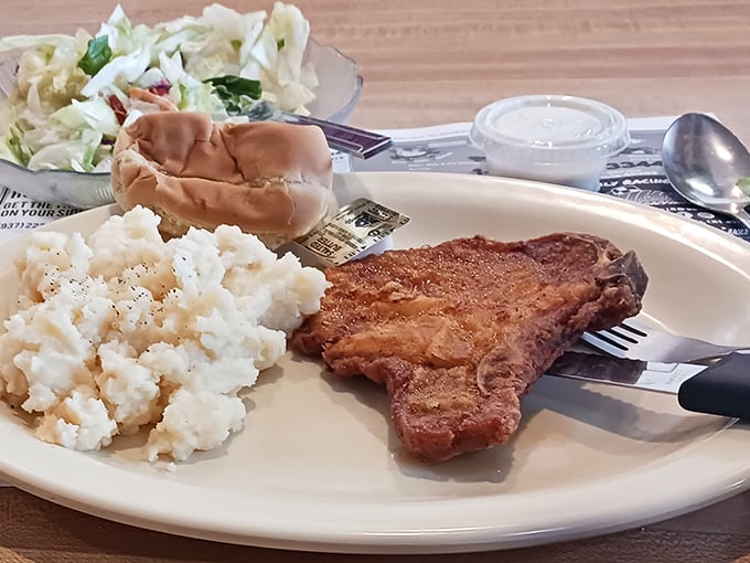 When mashed potatoes, gravy, and pork chop share a plate, it's not just dinner – it's therapy without the hourly rate.