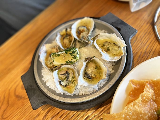 These oysters aren't just broiled—they're pampered spa guests lounging on a bed of salt, dressed in buttery finery.