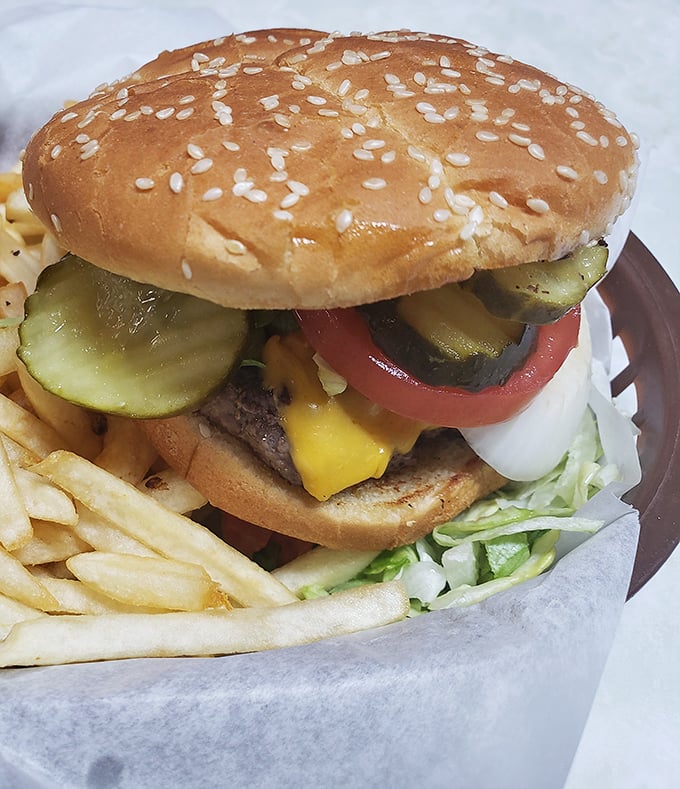This isn't just a burger—it's the American dream between two buns, complete with crisp vegetables and a side of golden fries.
