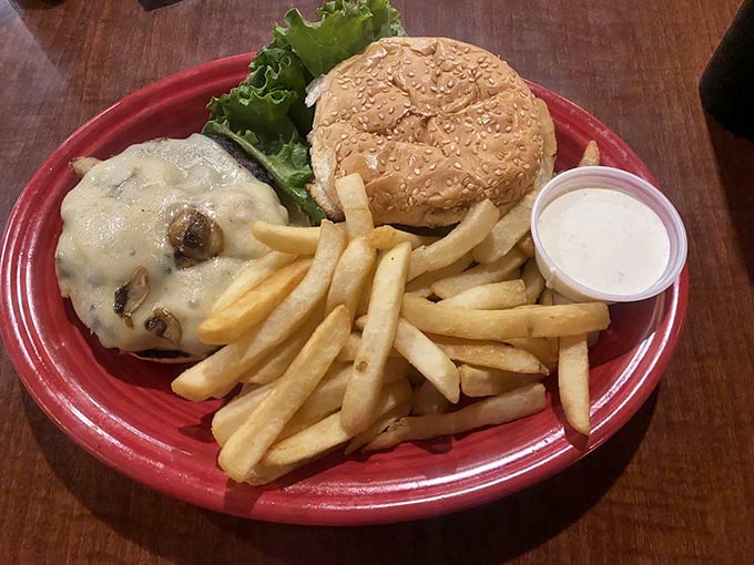 This burger isn't just a meal, it's an architectural achievement – melted cheese cascading over the patty like a dairy waterfall.