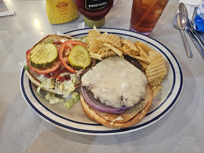 A burger that doesn't need Instagram filters to look this good—notice how the cheese drapes like a dairy waterfall over honest beef.