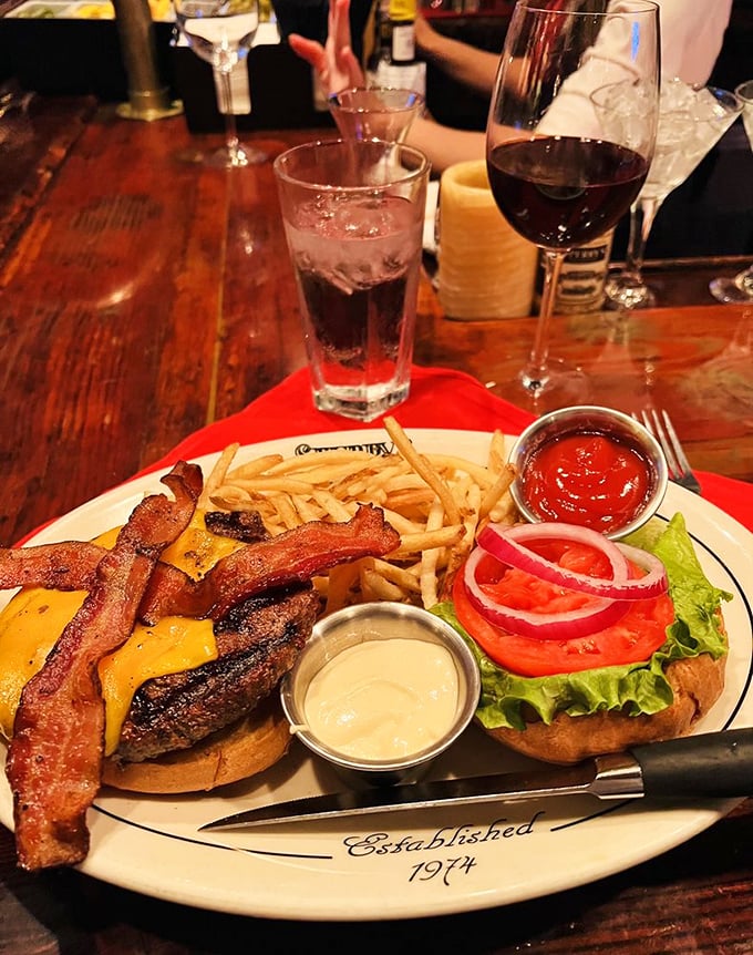 This isn't just a burger – it's a statement. Thick-cut bacon, melted cheese, and all the fixings on a plate that's seen generations of satisfied diners. 