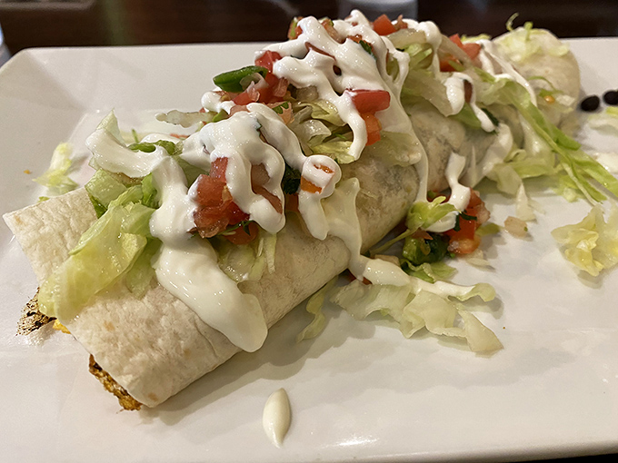These burritos are architectural marvels, stuffed with care and topped with fresh lettuce and creamy sauces.