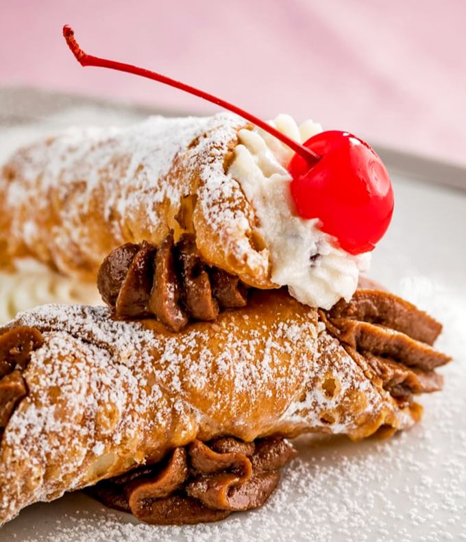 The cannoli—crisp, golden shells filled with sweet ricotta—would make any Sicilian grandmother nod in silent approval.