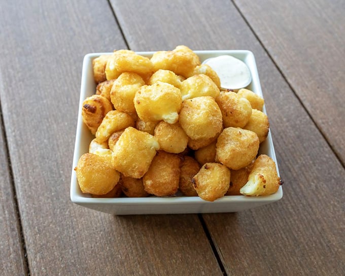 Golden cheese curds arrive perfectly crispy, ready to convert anyone who thinks cheese belongs only on pizza.