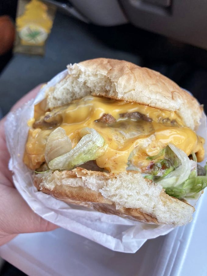 The cheeseburger that launched a thousand cravings—melty American cheese cascading over beef with that perfect hint of lettuce crunch.