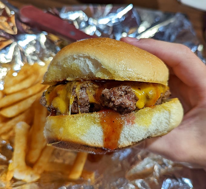 This isn't just a burger – it's a hand-held celebration. Melted cheese cascading down seasoned beef with sauce that demands both napkins and respect.