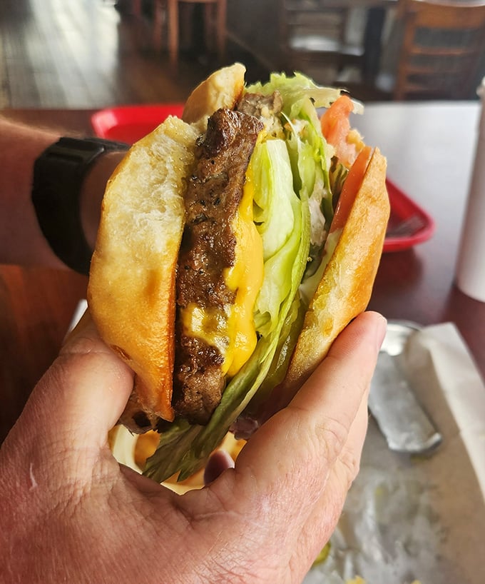 Not just a burger—a statement. When cheese, meat, and fresh veggies come together like this, conversation stops and appreciation begins.