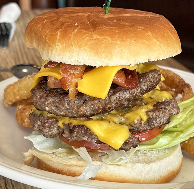 This isn't just a burger—it's a towering monument to beef that makes you wonder if your jaw will unhinge like a python's.