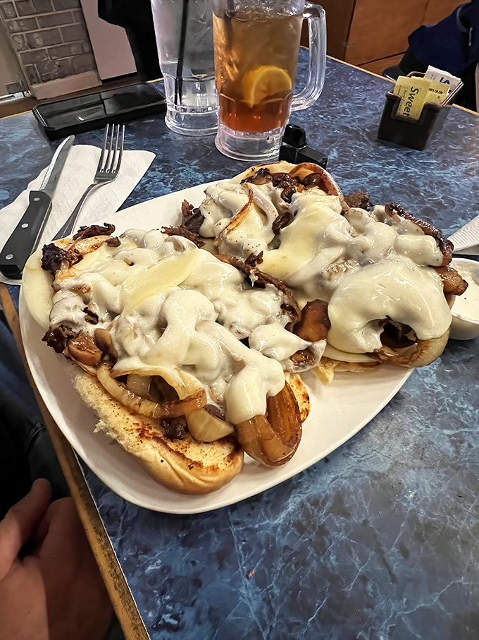 This isn't just a cheesesteak—it's a monument to excess. Melted cheese cascades over tender beef like a dairy waterfall of dreams.
