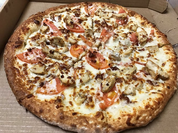 A pizza that doesn't hold back – chicken, bacon, and veggies atop a creamy white sauce. It's like comfort food having a party and inviting all its friends.