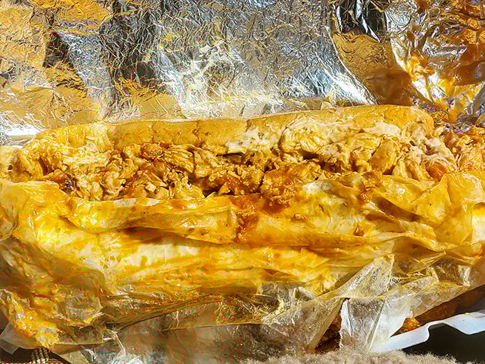 The chicken cheesesteak wrapped in foil like a gift—because that's exactly what it is to your taste buds.